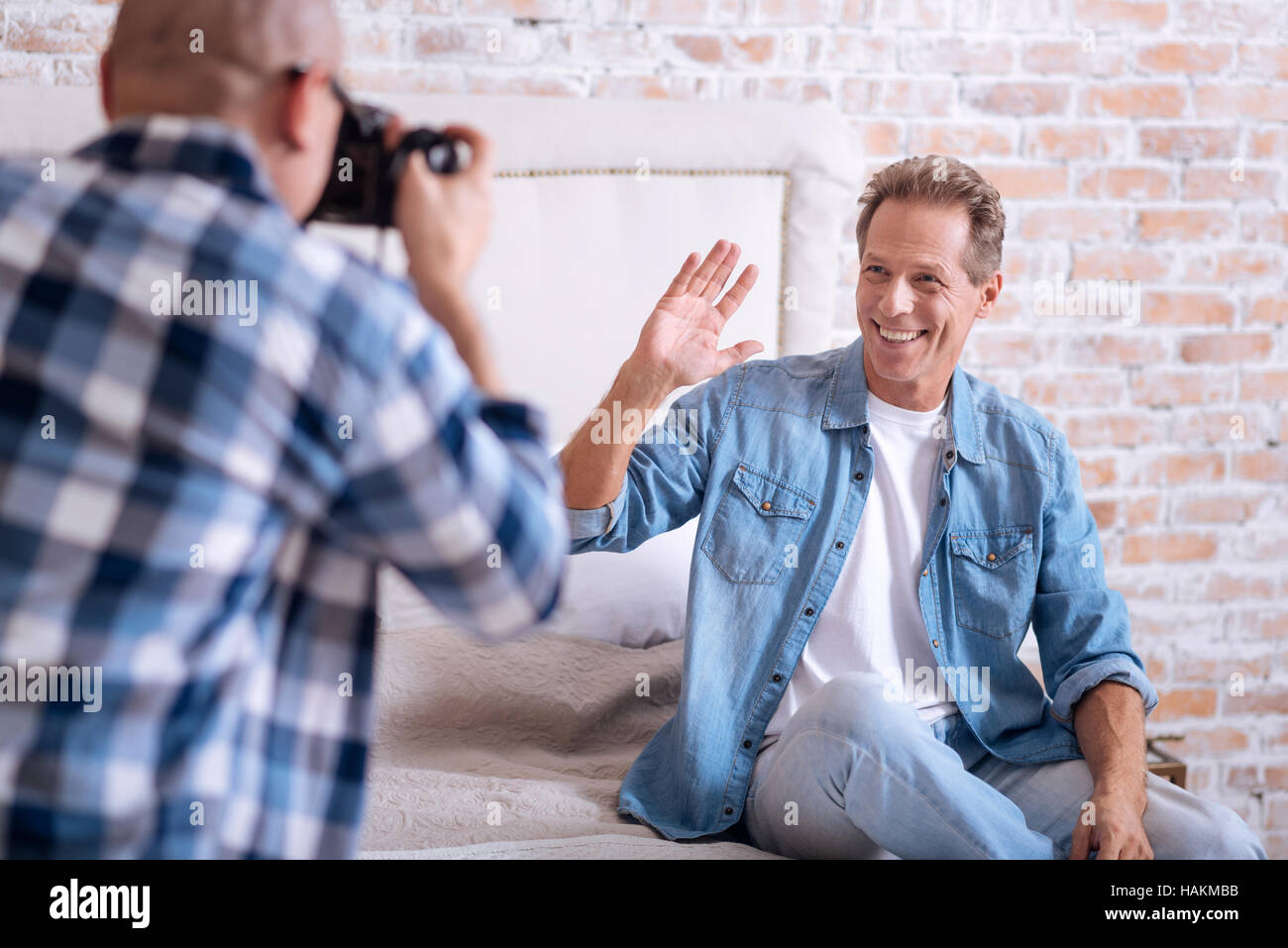 Positive aged man posing for the photographer Stock Photo - Alamy