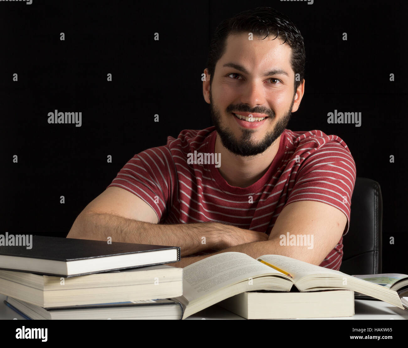 Young man many books hi-res stock photography and images - Alamy