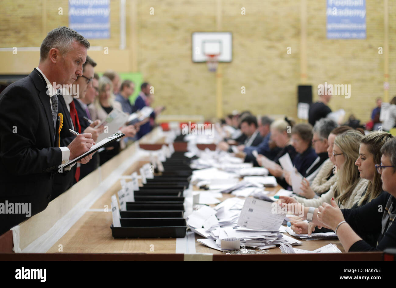 Counting agents for the candidates look at the ballot papers arriving ...