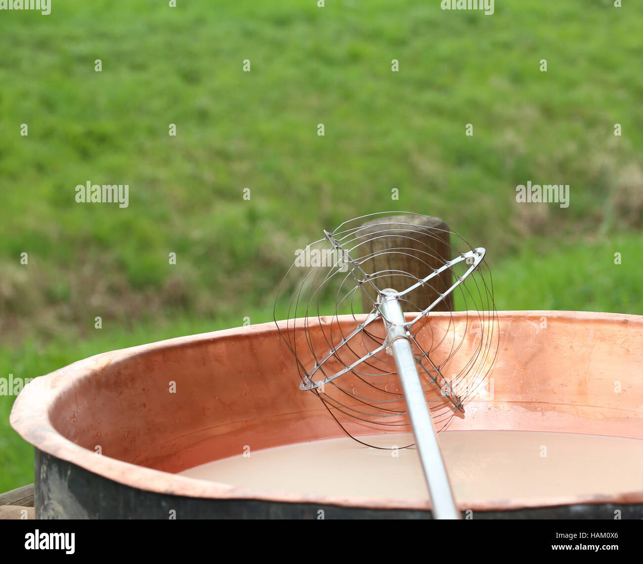 special tool to mix the rennet milk in the copper cauldron to produce ...