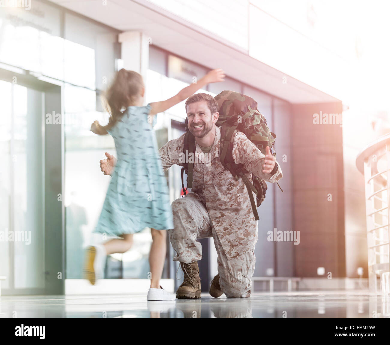 Daughter running and greeting soldier father in airport concourse Stock ...