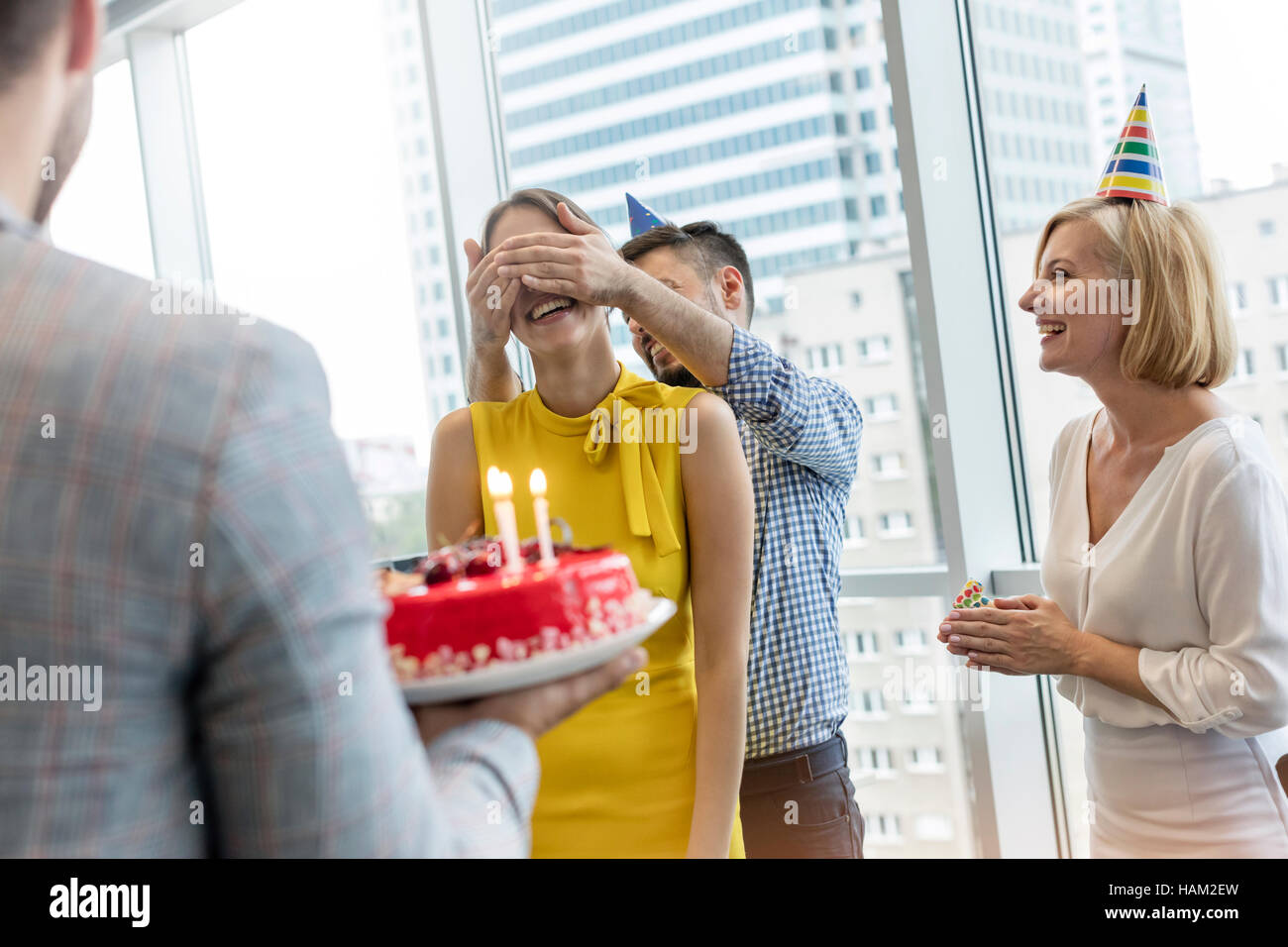 Business people celebrating birthday with cake in office Stock Photo ...
