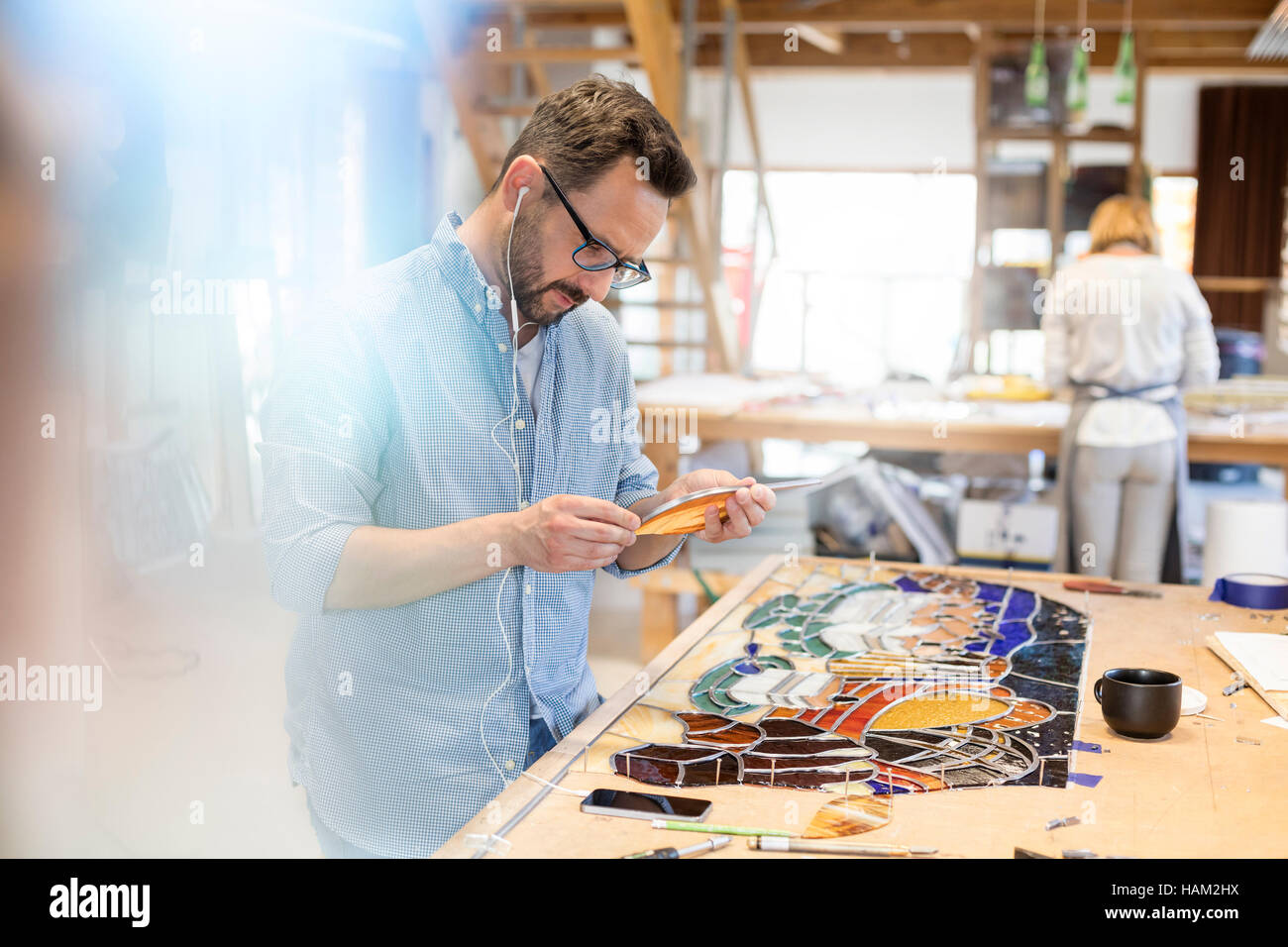 Stained glass artist working in studio Stock Photo - Alamy