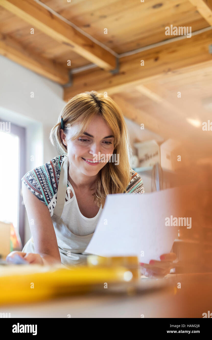 Smiling artist working in studio Stock Photo - Alamy