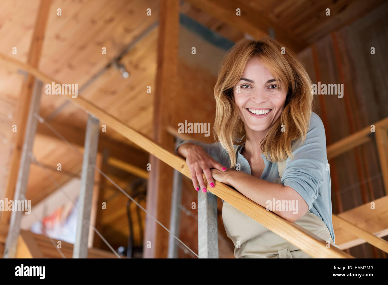 Portrait smiling artist on staircase Stock Photo - Alamy