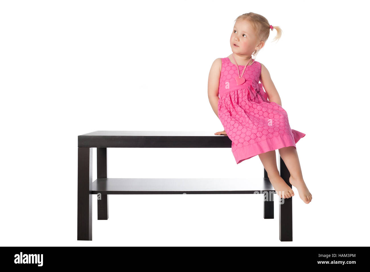 little girl on the table isolated Stock Photo - Alamy