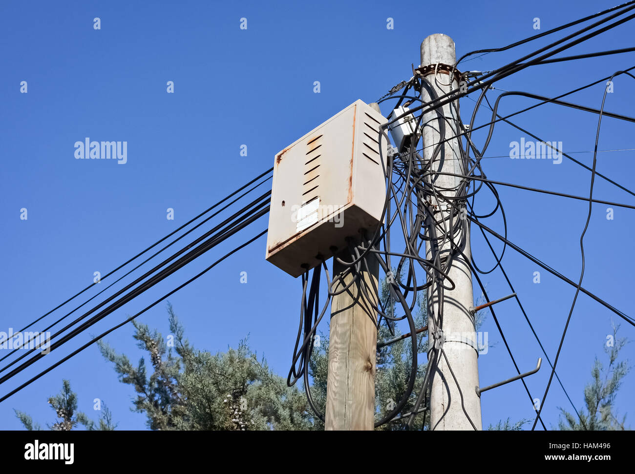 Mess of electric cables and distribution box on a small pylon Stock ...