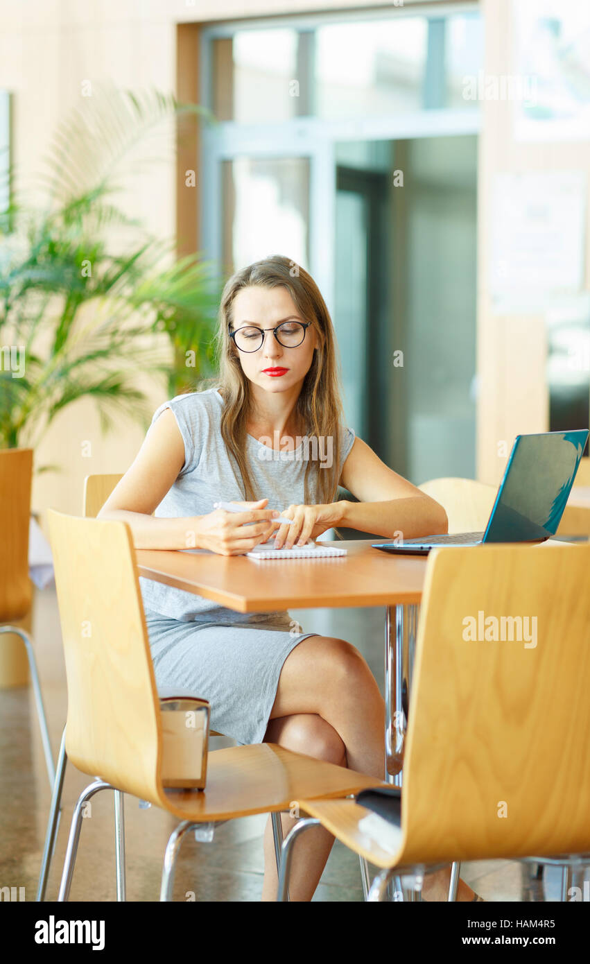 Young attractive business woman sitting in a cafe with a laptop Stock ...