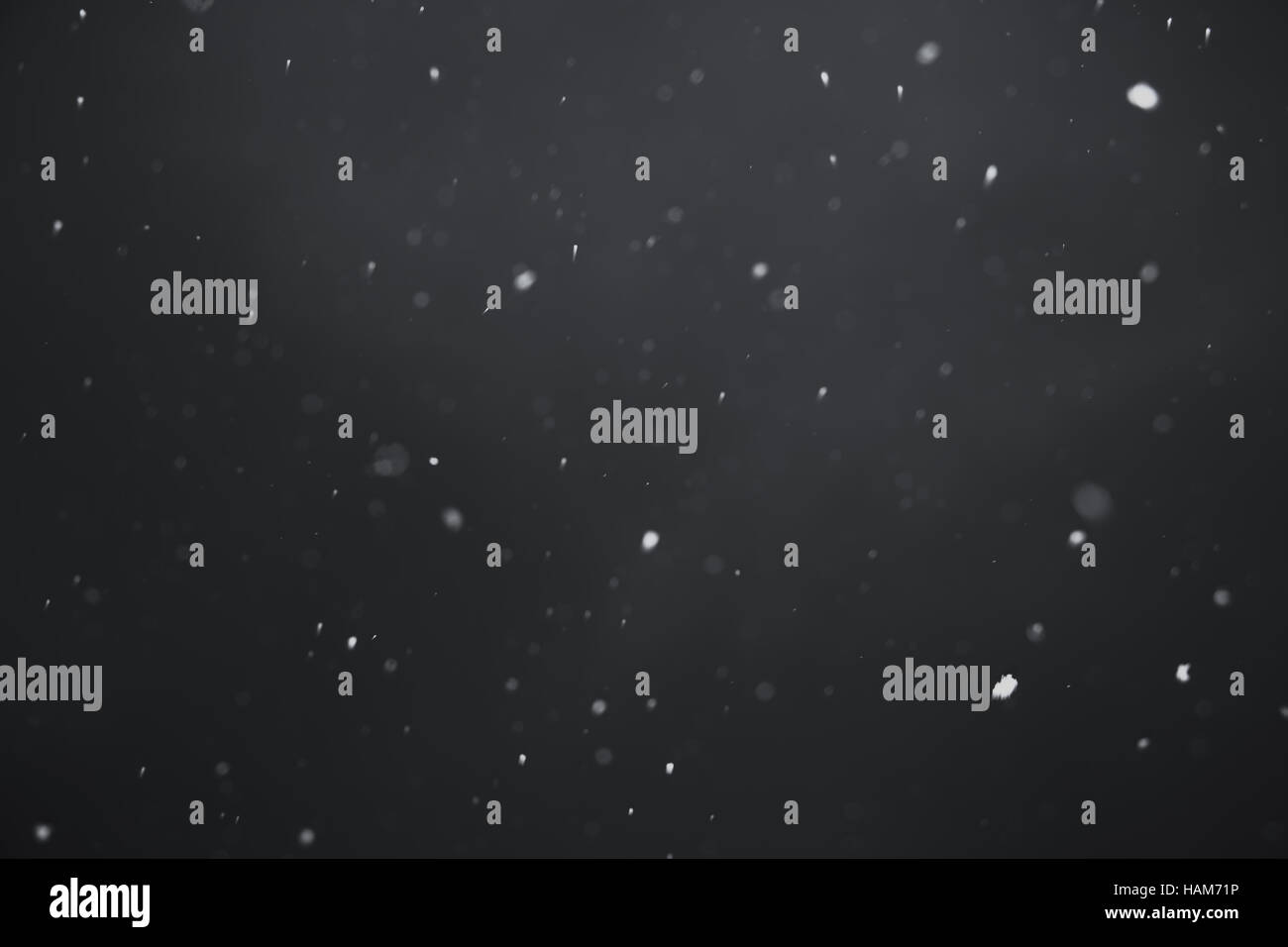 Falling snow on black background Stock Photo - Alamy