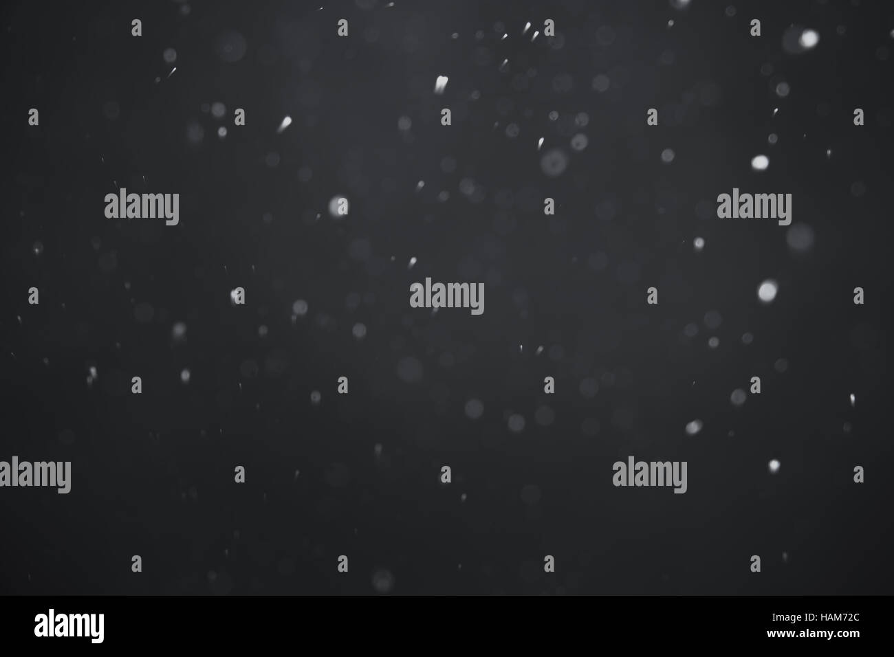 Falling snow on black background Stock Photo - Alamy