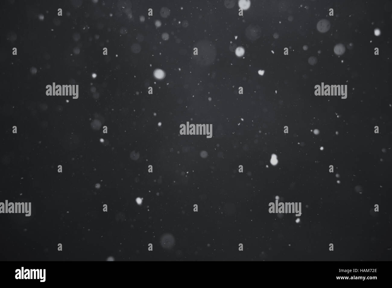 Falling snow on black background Stock Photo - Alamy
