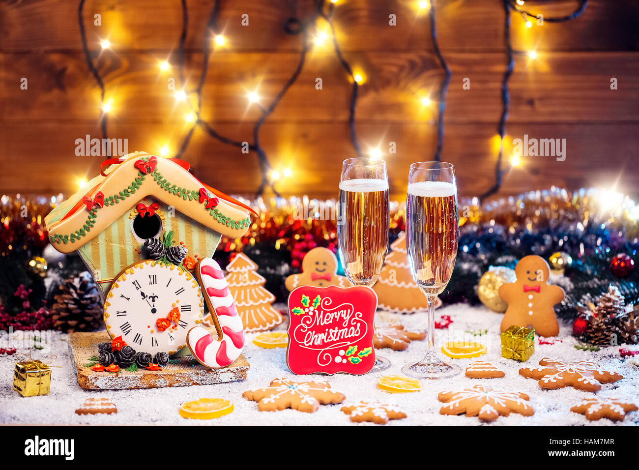 Christmas Gingerbread House with clock and two glass champagne with fir ...