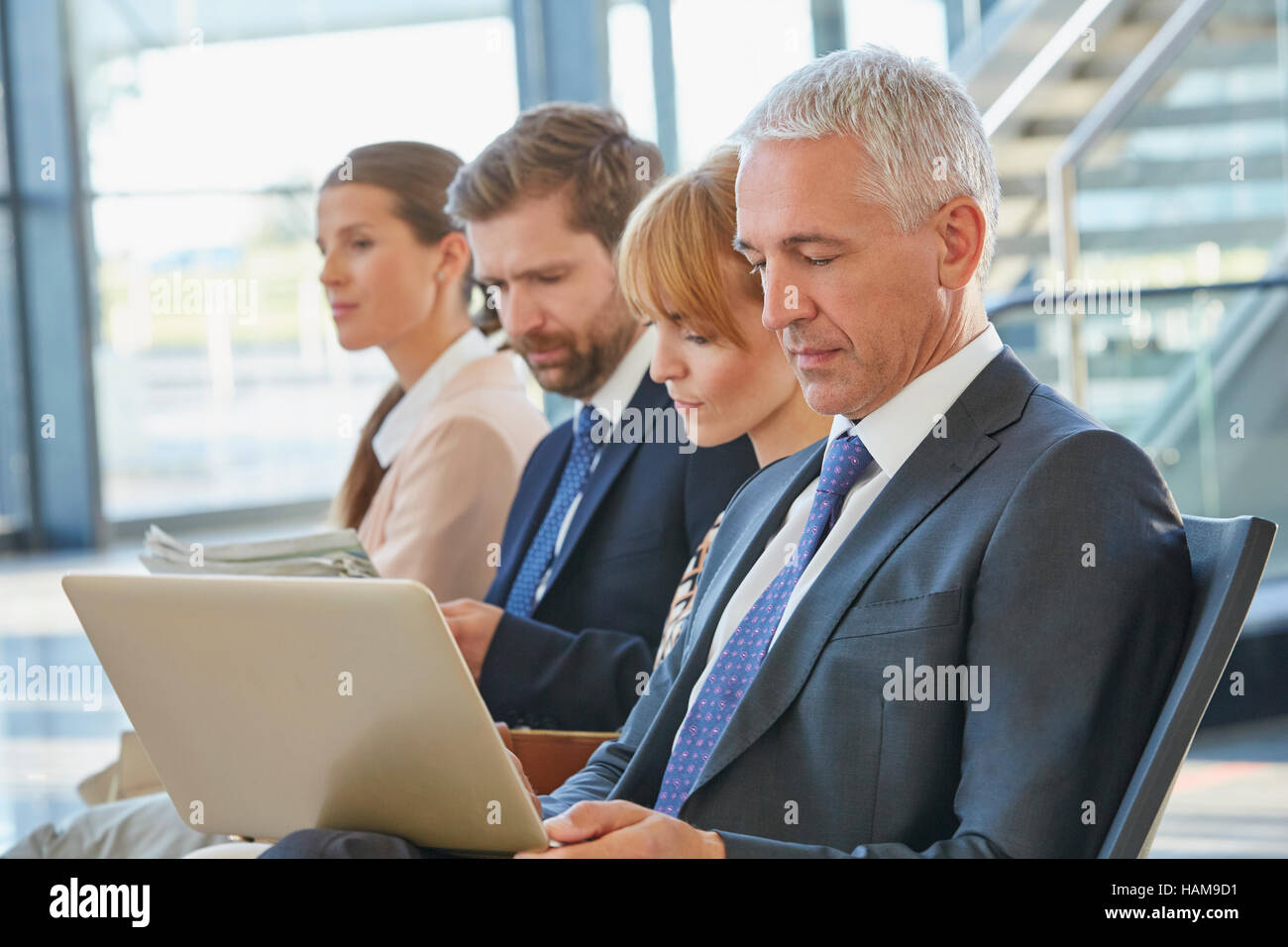 Businessman using laptop airport departure hi-res stock photography and ...