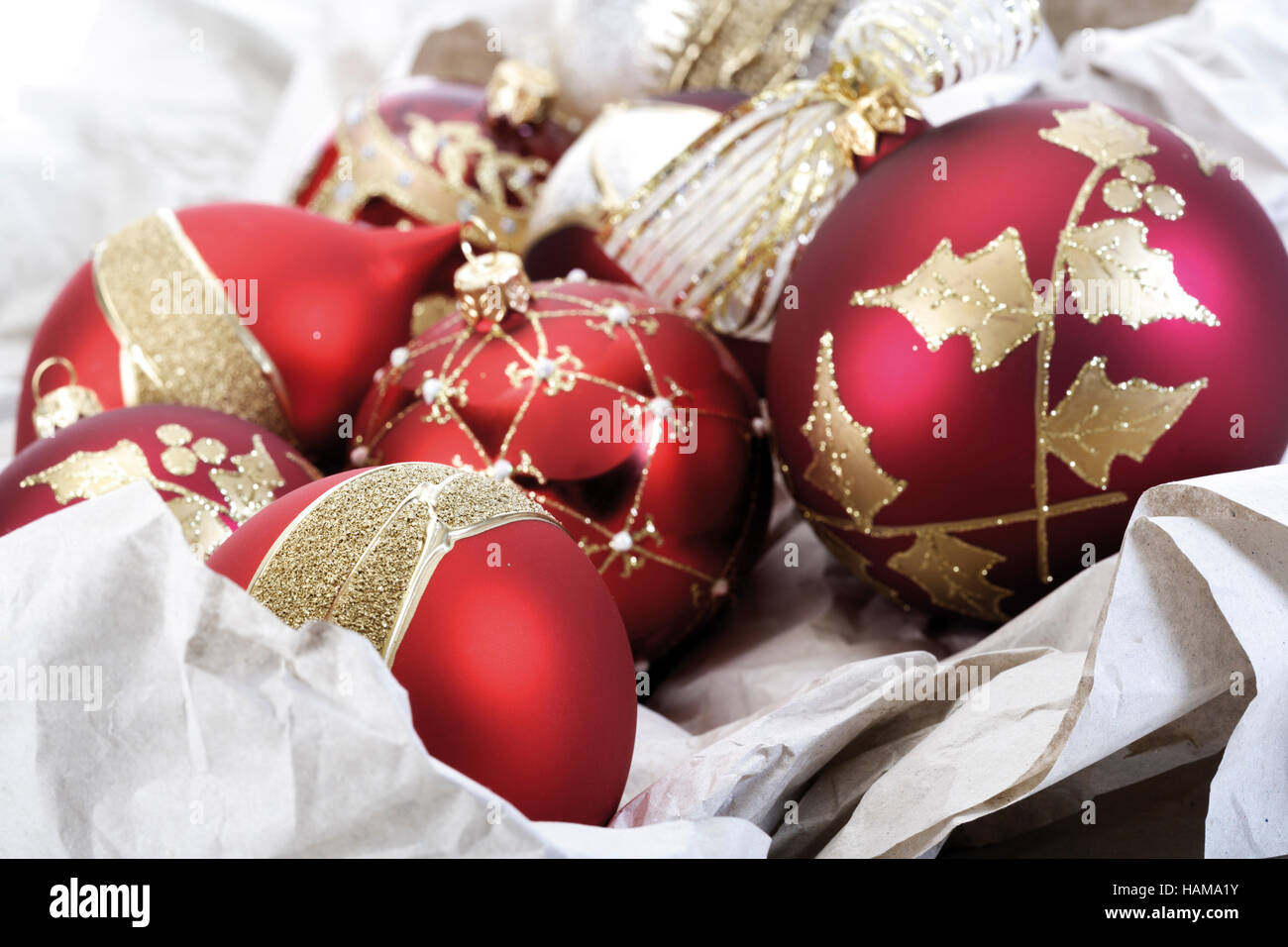 Red Christmas tree baubles in paper Stock Photo - Alamy