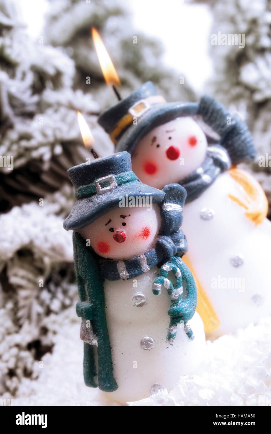Snowman candles in a snowy forest Stock Photo - Alamy