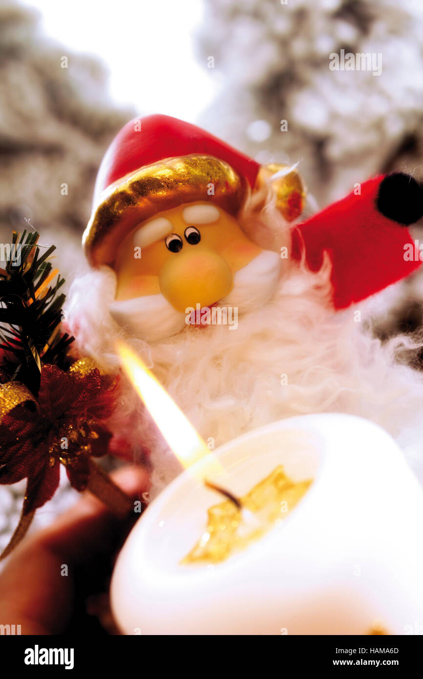 Candle with a Santa Claus figure Stock Photo - Alamy