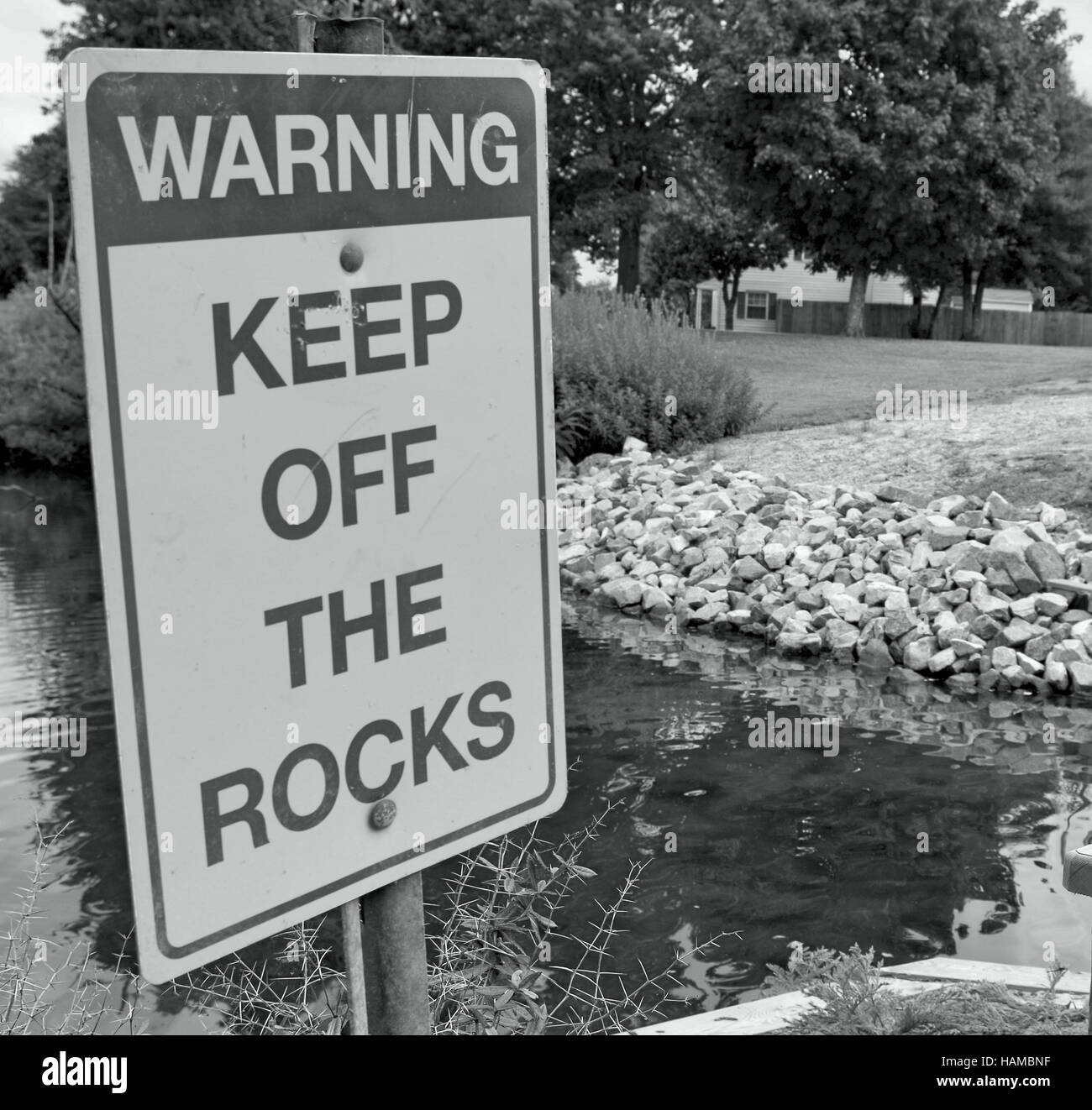A keep off the rocks sign (B&W Stock Photo - Alamy
