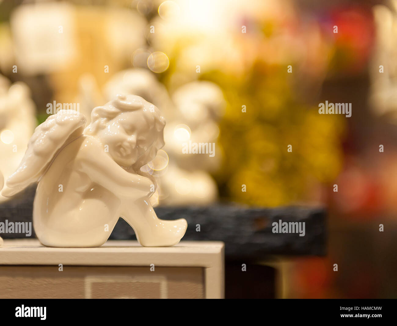 Angel sitting seat on the box porcelain figurine Stock Photo - Alamy