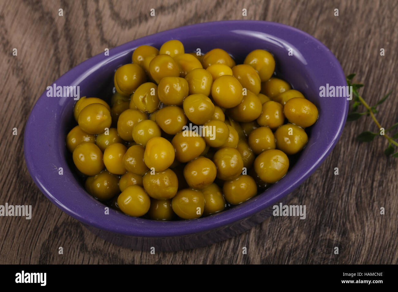 Pickled pea in the plate over wooden background Stock Photo - Alamy