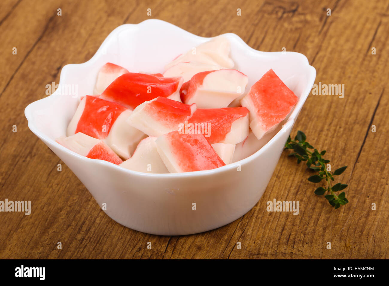 Crab stick - surimi in the plate - over wood background Stock Photo - Alamy