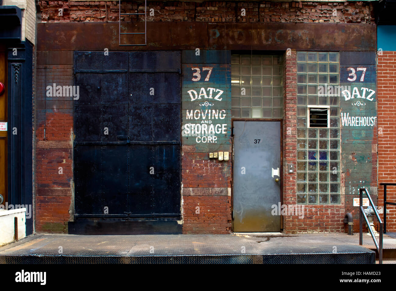 industrial brick painted moving and storage sign on loading dock in ...