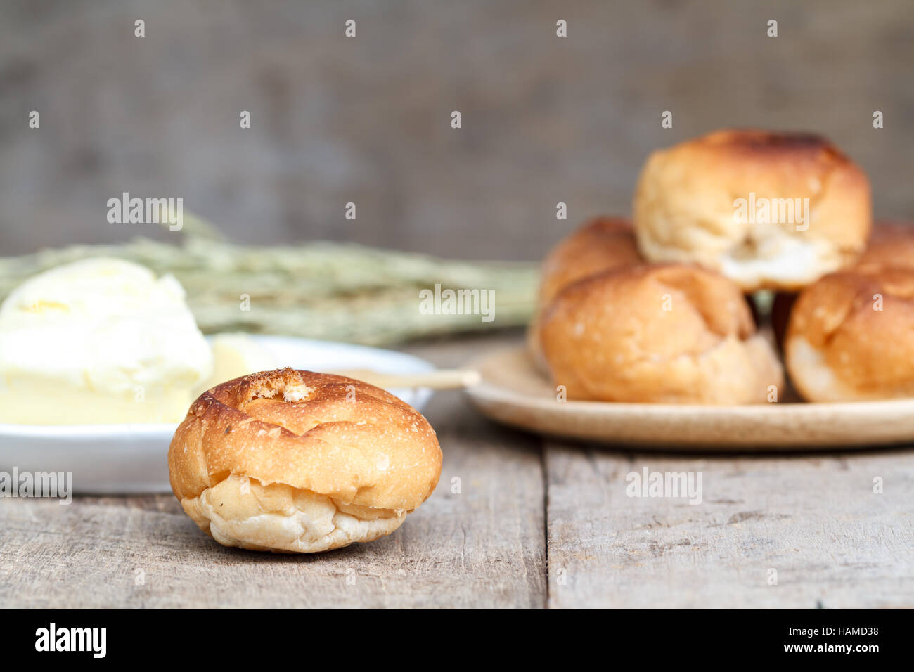 Soft bun roll and butter on wood table Stock Photo - Alamy