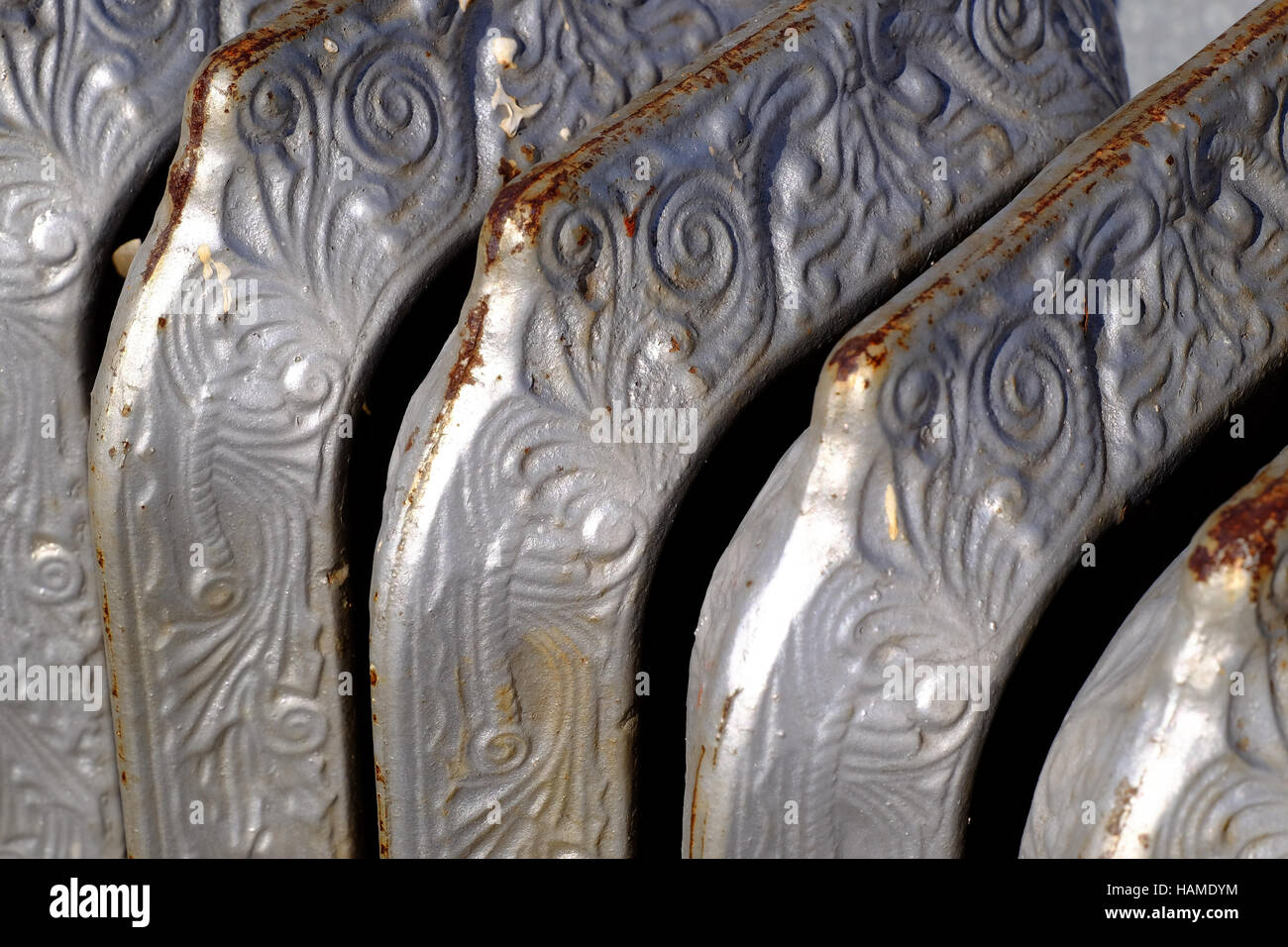 The details of an old steam radiator shine in the sunlight in a salvage ...
