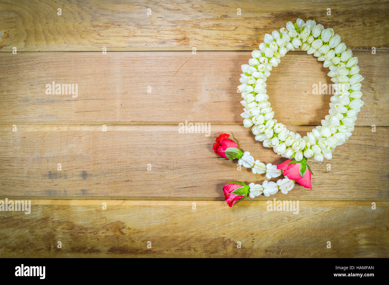 Flower garland on wooden background Stock Photo - Alamy