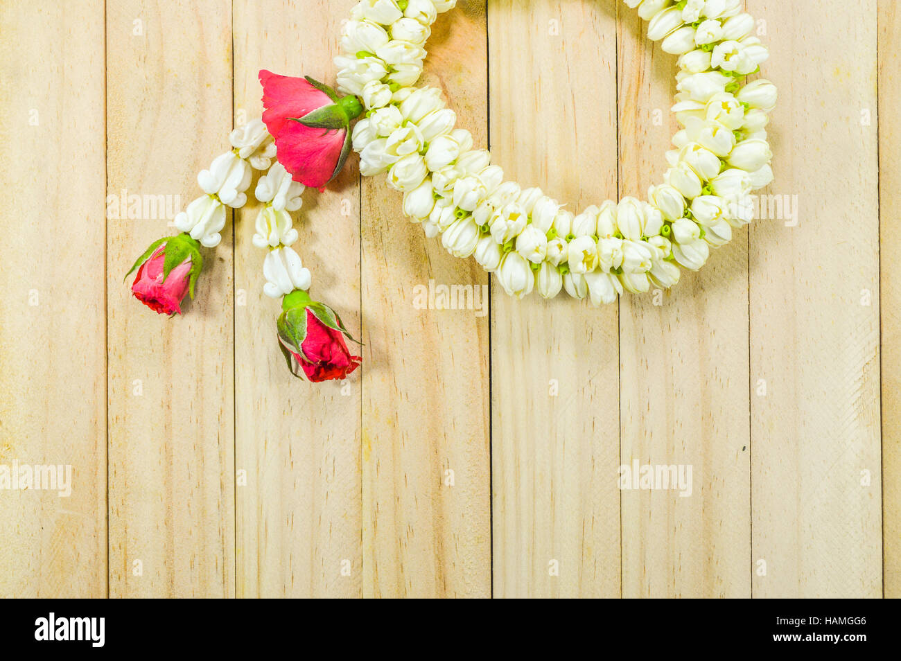 Flower garland on wooden background Stock Photo - Alamy