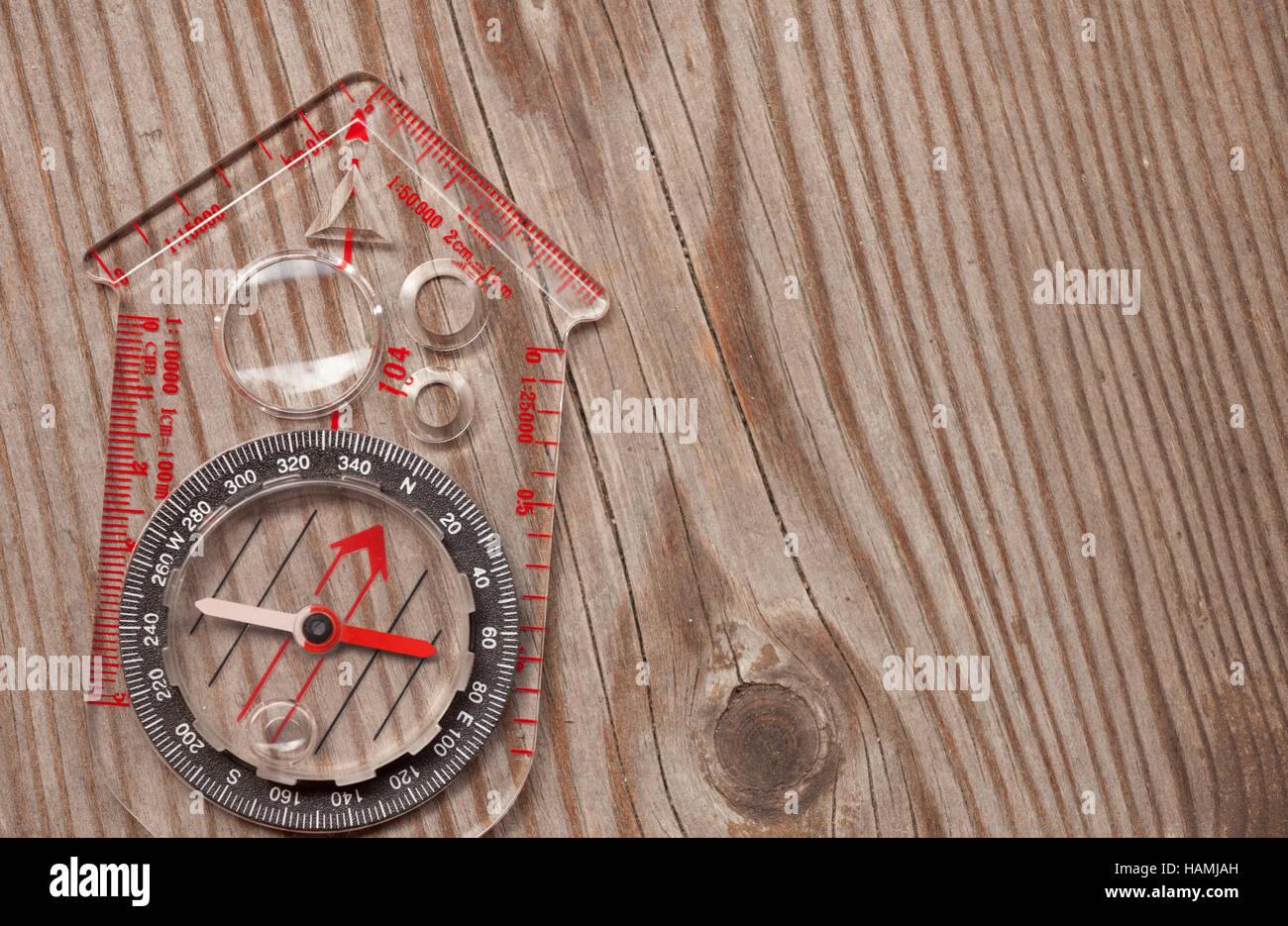 plastic compass over a wooden background Stock Photo - Alamy