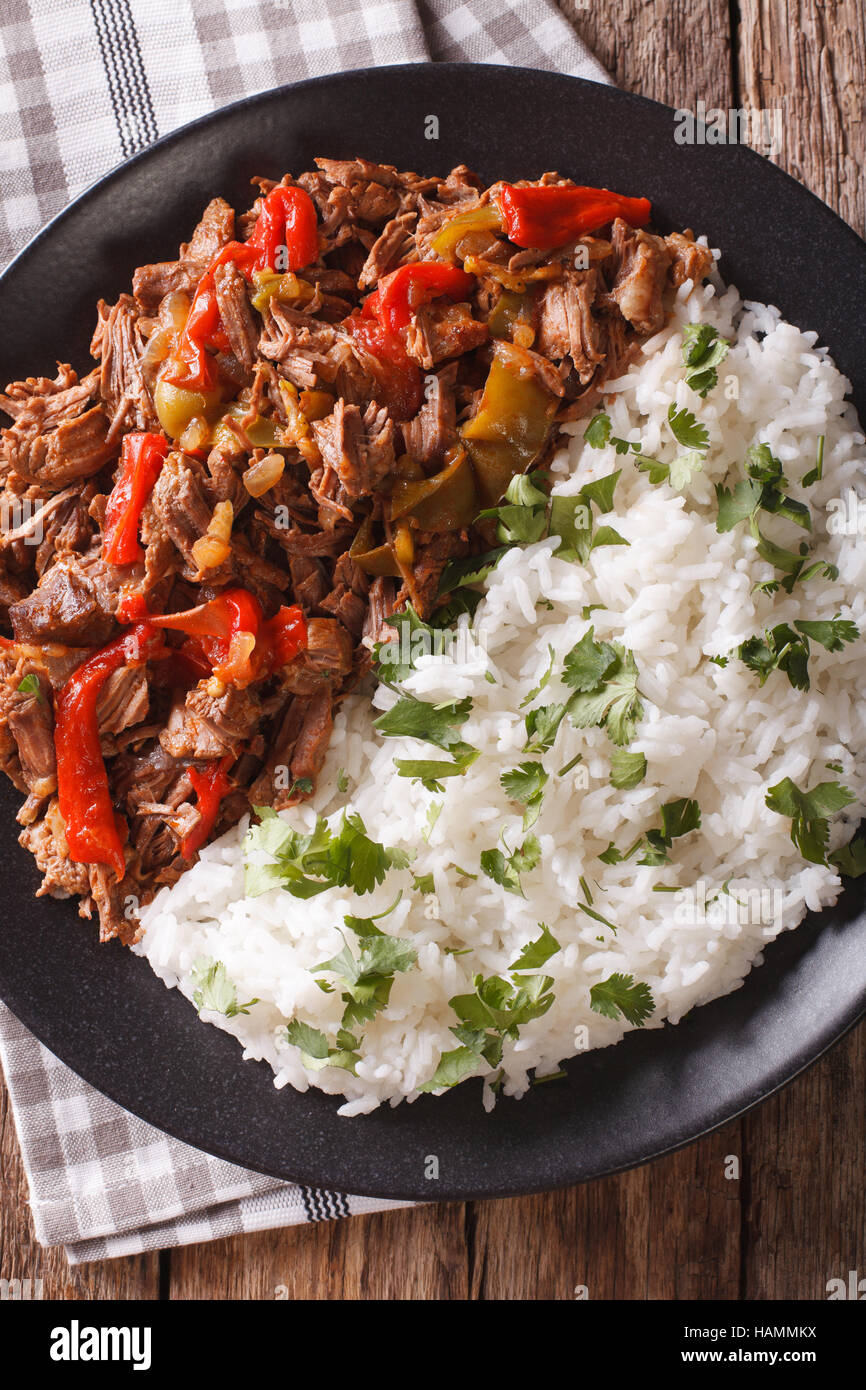 Latin American cuisine: ropa vieja with rice close-up on a plate ...