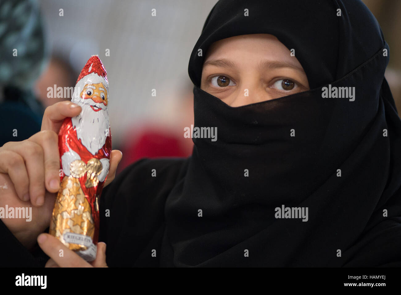 Friedland, Germany. 2nd Dec, 2016. Iman from Syria shows her chocolate ...