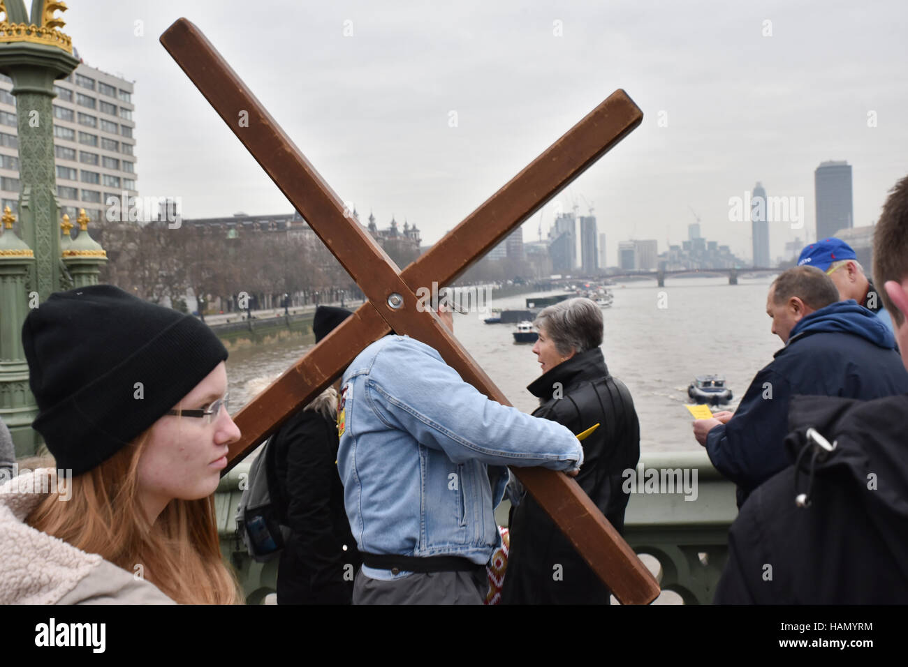 Westminster Bridge, London, UK. 2nd Dec, 2016. A man carrying cross ...