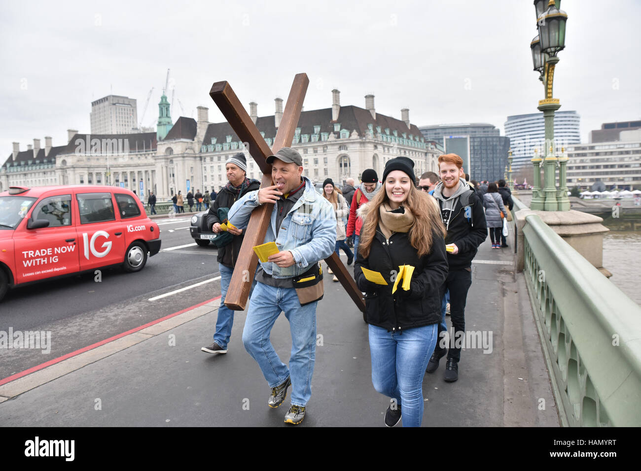 Westminster Bridge, London, UK. 2nd Dec, 2016. A man carrying cross ...