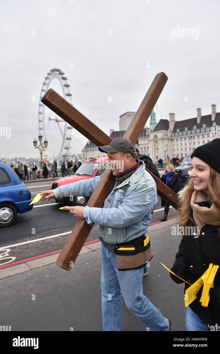 Westminster Bridge, London, UK. 2nd Dec, 2016. A man carrying cross ...