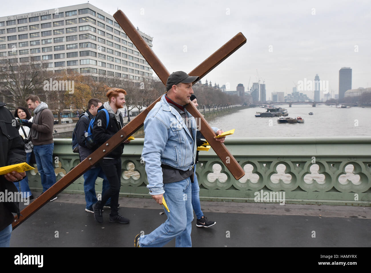 Westminster Bridge, London, UK. 2nd Dec, 2016. A man carrying cross ...