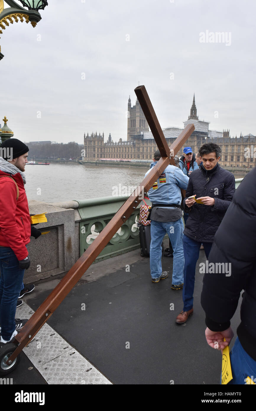 Westminster Bridge, London, UK. 2nd Dec, 2016. A man carrying cross ...