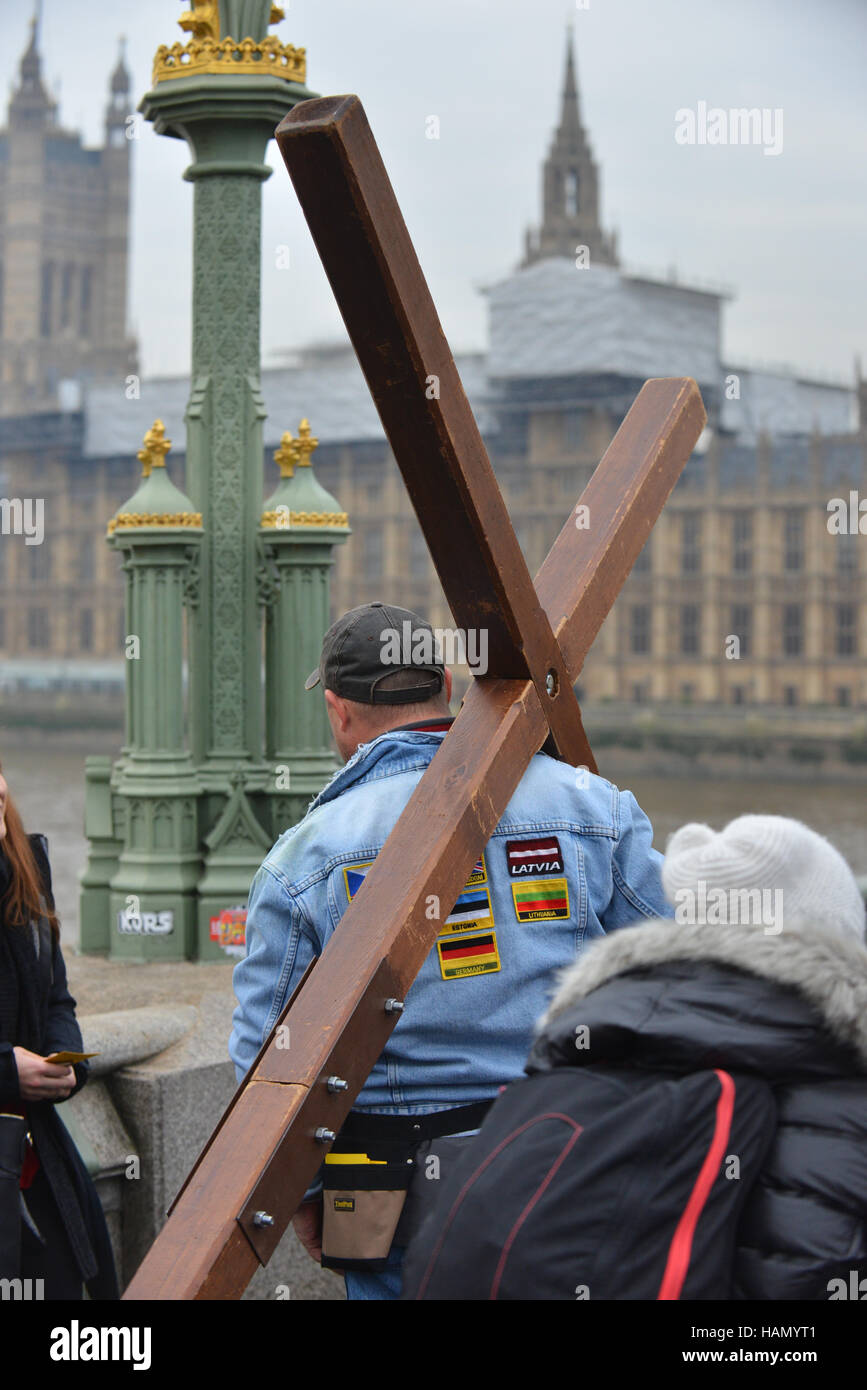 Westminster Bridge, London, UK. 2nd Dec, 2016. A man carrying cross ...