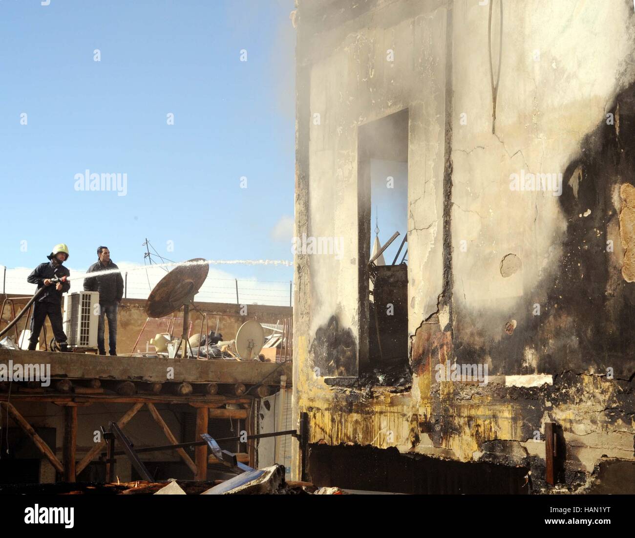 Damascus, Syria. 2nd Dec, 2016. A firefighter helps extinguish a fire ...