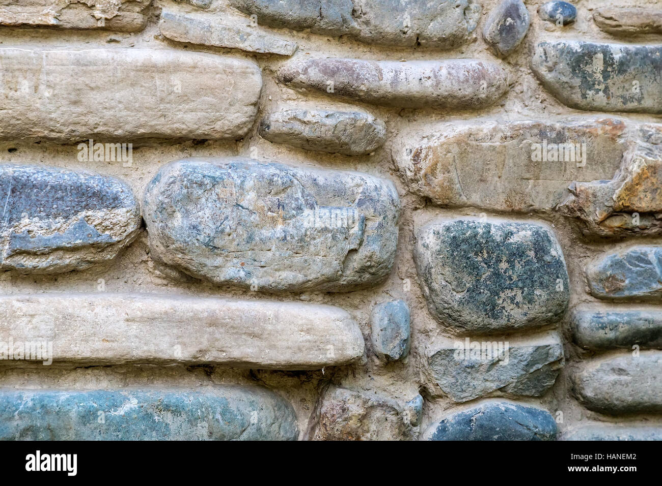 Fragment of the ancient stone wall executed from stones of various form ...