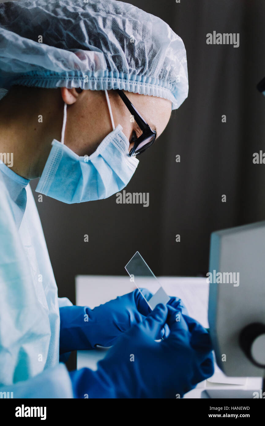 Female scientist arranging microscope glasses in box Stock Photo - Alamy