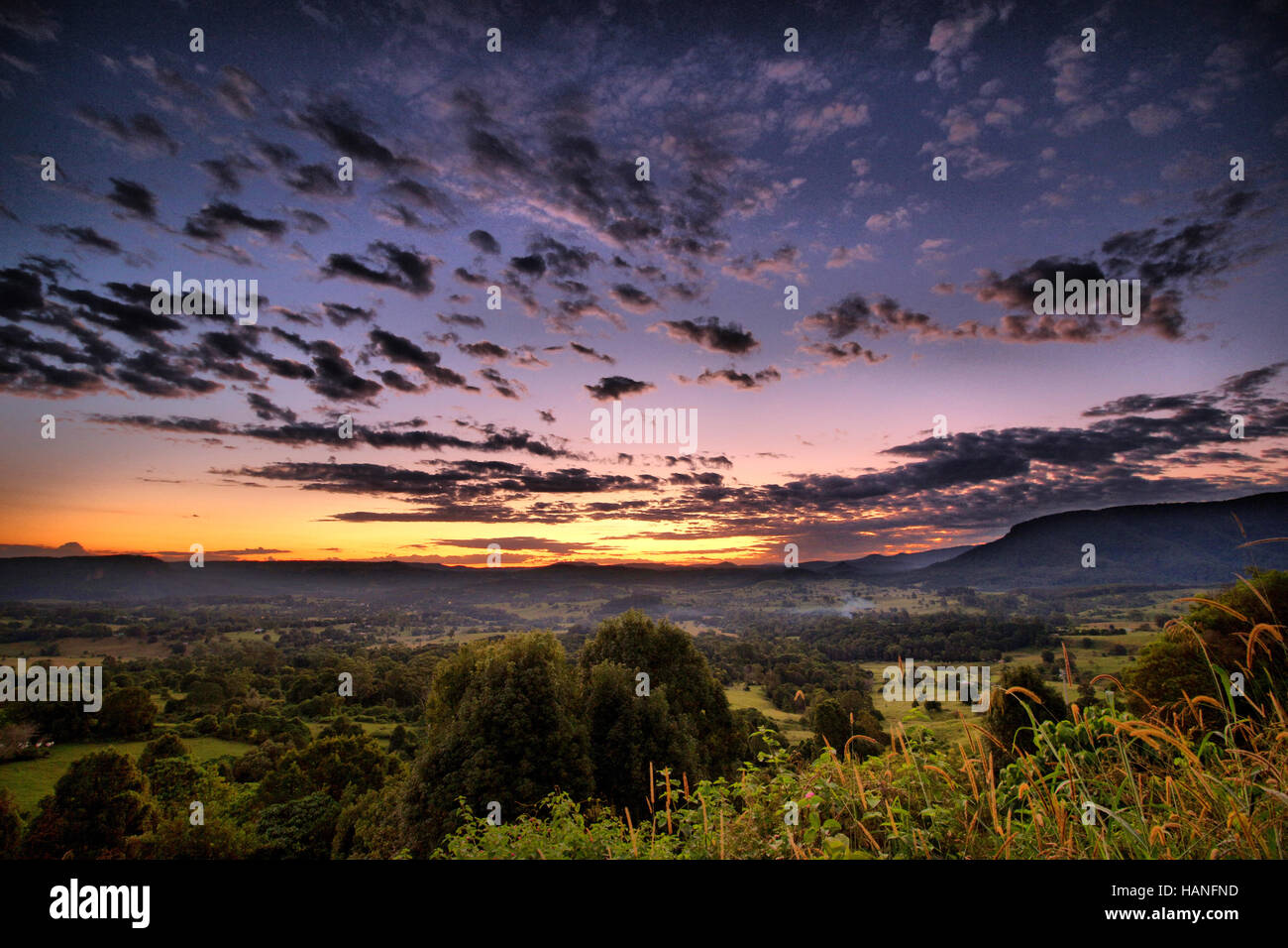Sunset over a picturesque landscape Stock Photo - Alamy