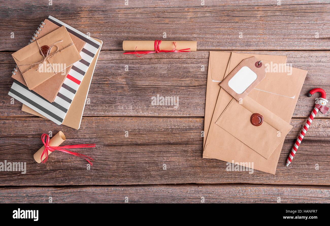 Notebooks and envelope on a wooden background Stock Photo - Alamy