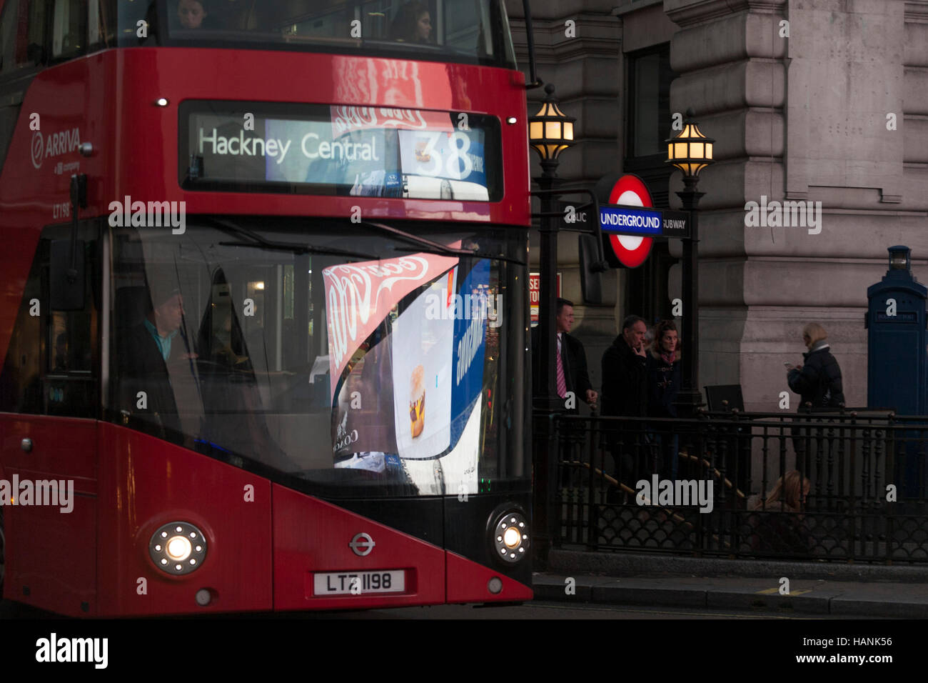 Advertising reflected in a London bus windows at dusk in Piccadilly ...