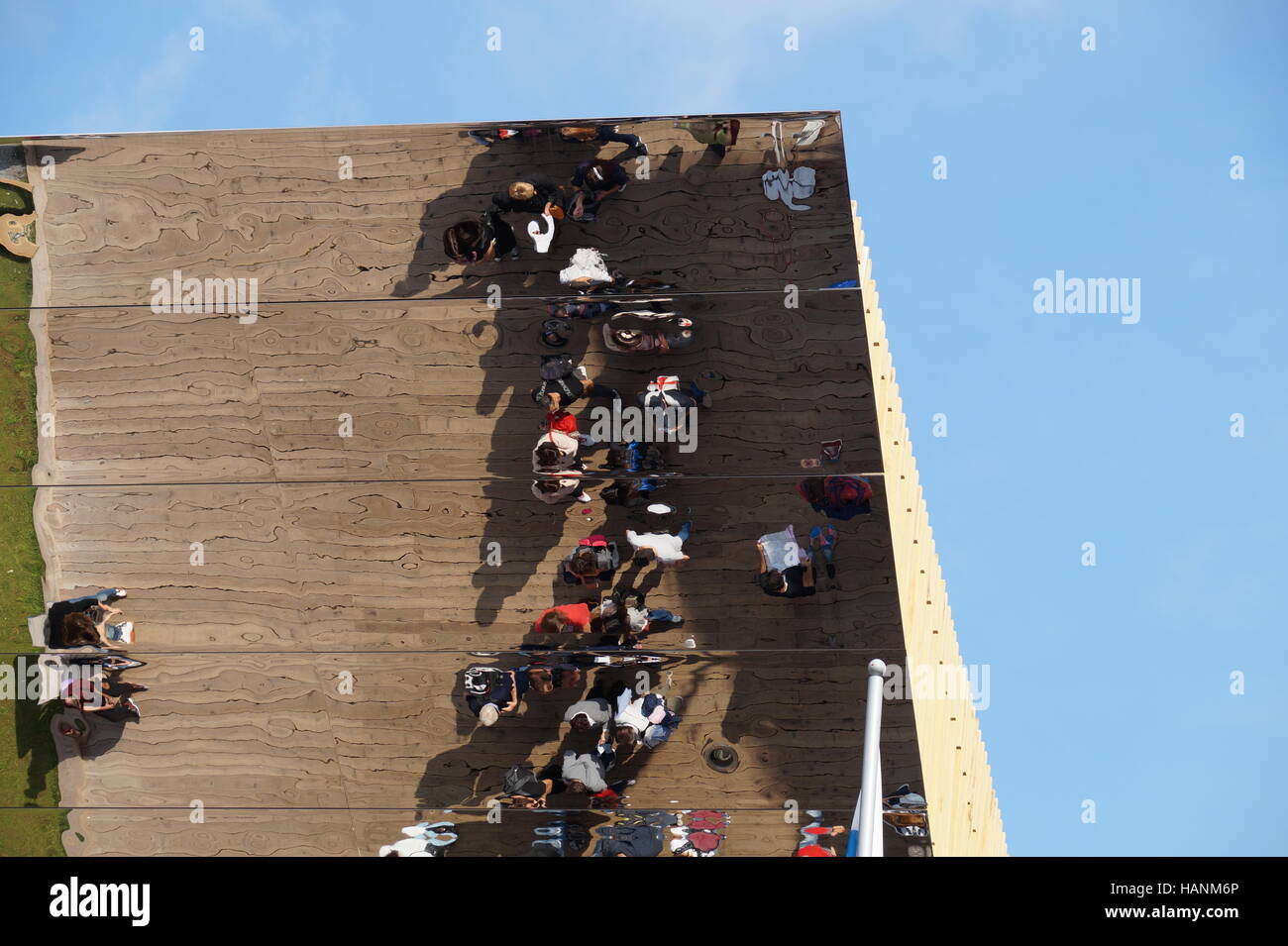 People reflections on colorful mirror at line Stock Photo - Alamy