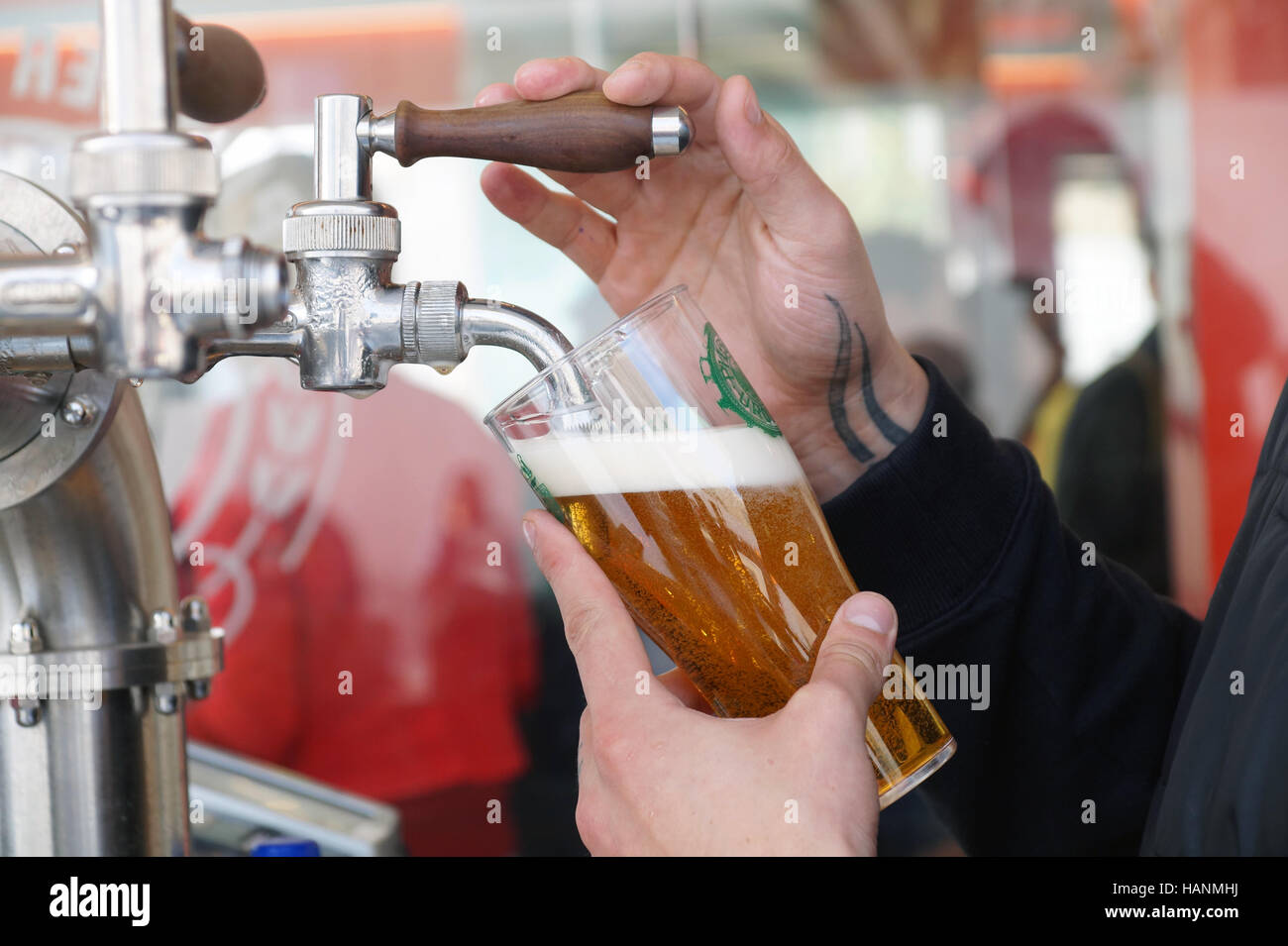 man brooch draft beer during demonstration. is an alcoholic beverage ...