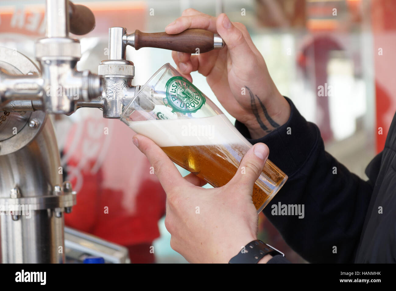 man brooch draft beer during demonstration. is an alcoholic beverage ...