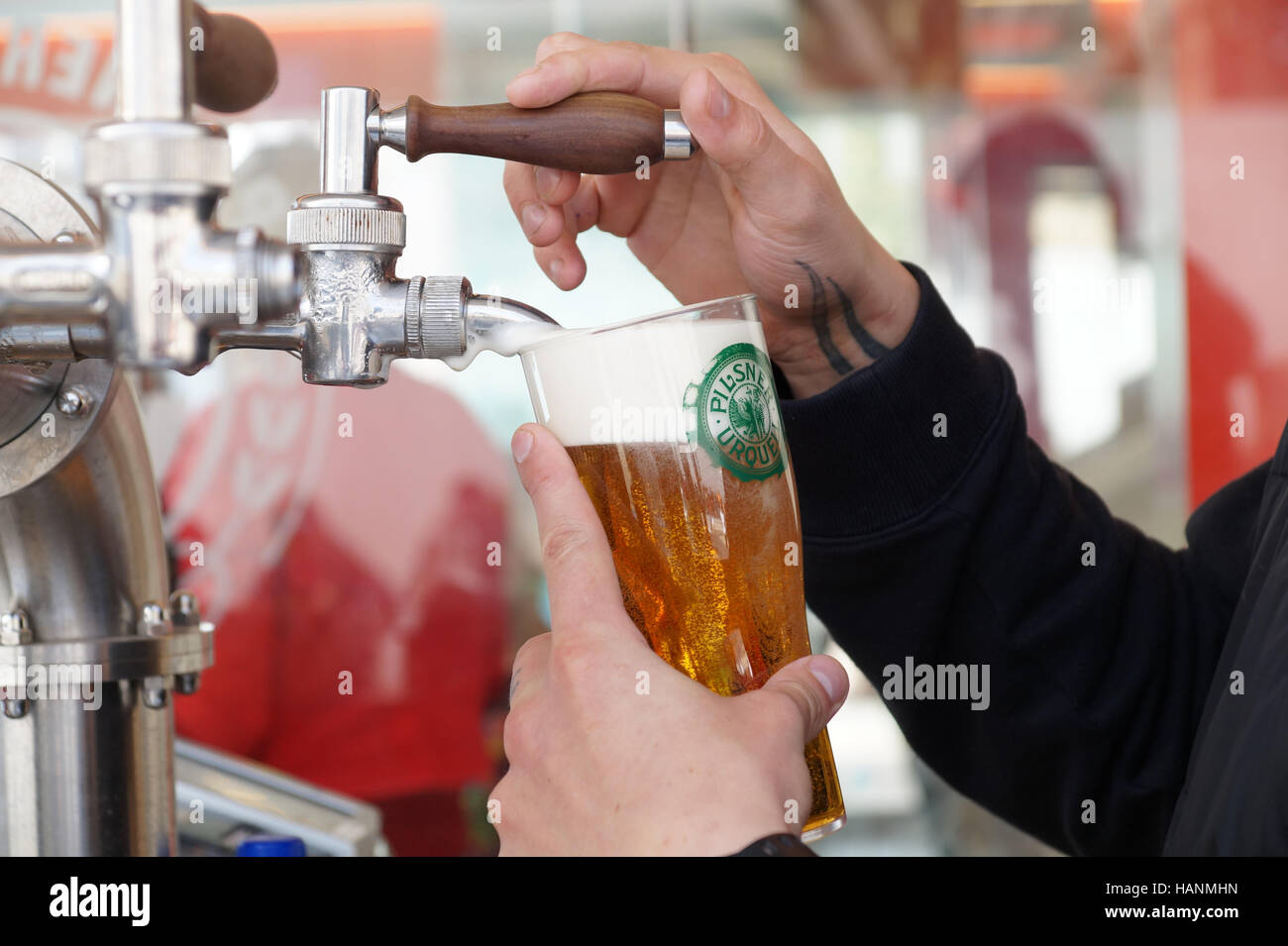 man brooch draft beer during demonstration. is an alcoholic beverage ...