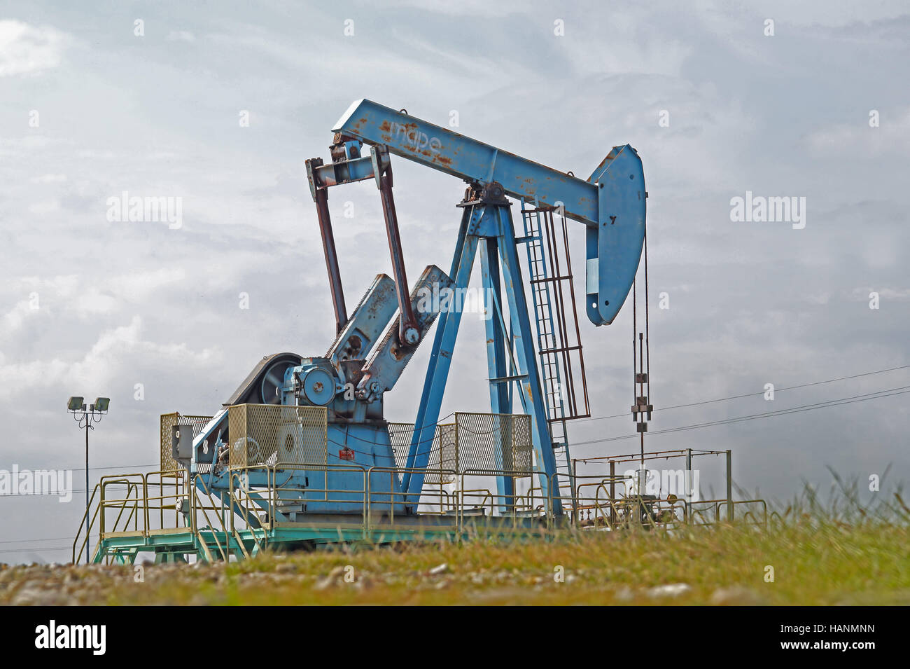 crank balanced beam pumping unit under the curtain Stock Photo - Alamy
