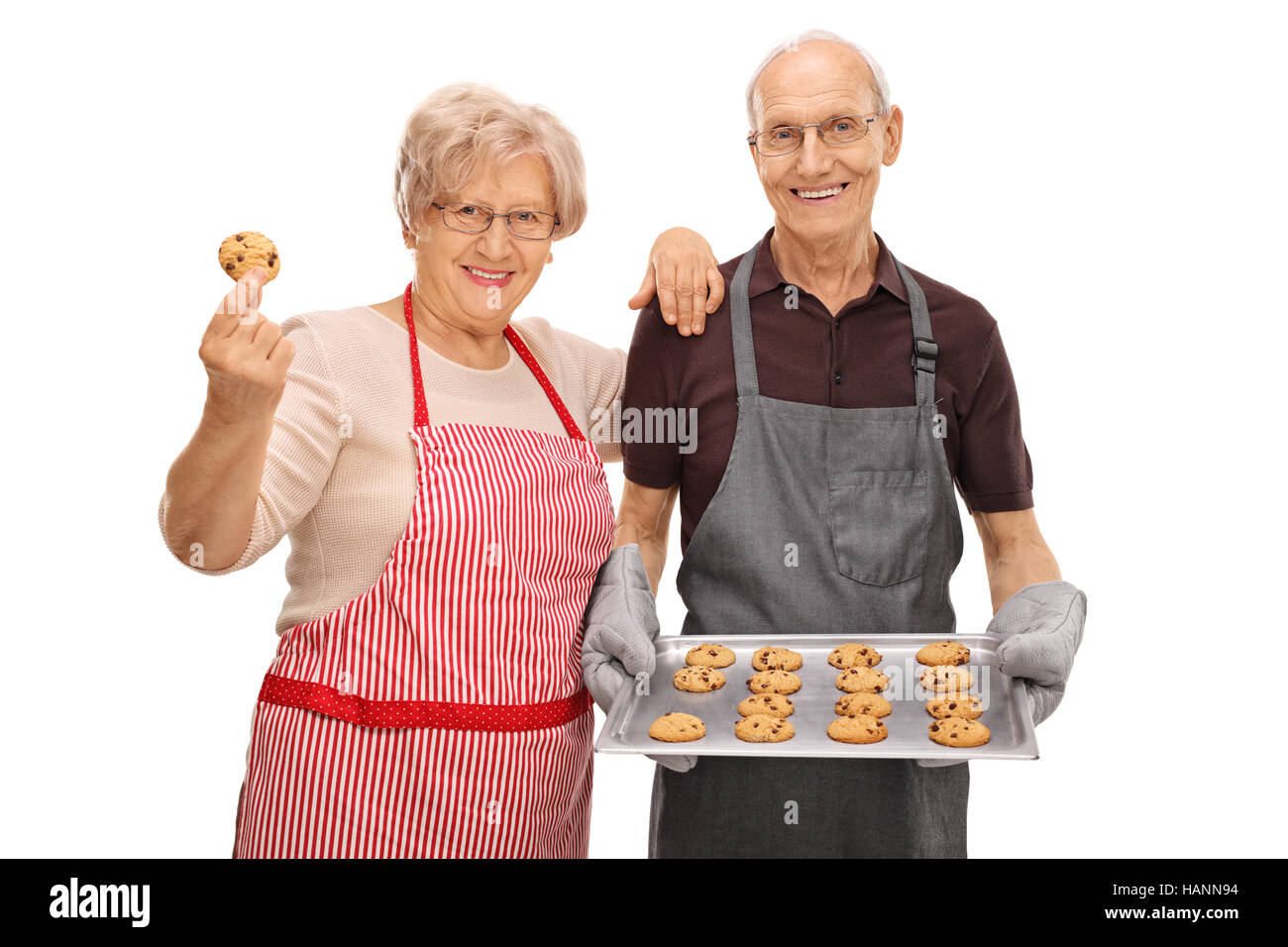 Elderly man holding a tray of freshly baked cookies and an elderly ...